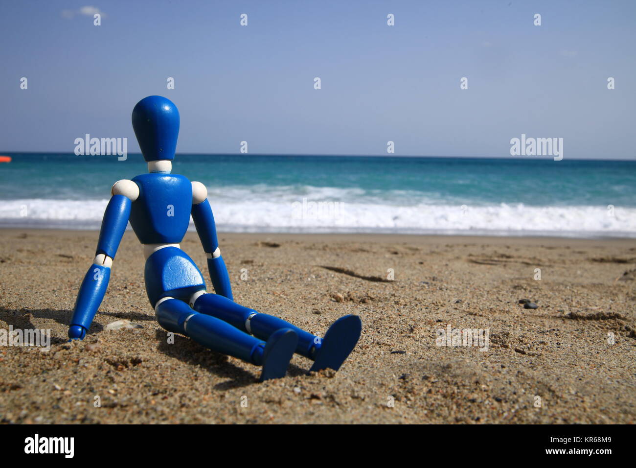 wooden figurine on beach Stock Photo - Alamy