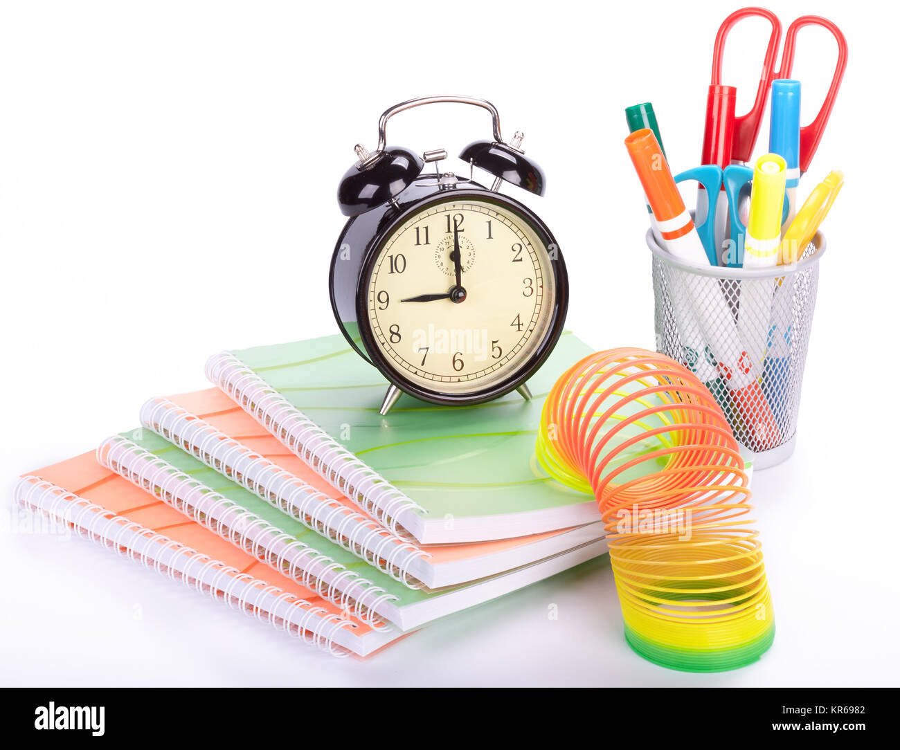 Pile of writing-book and alarm clock Stock Photo - Alamy