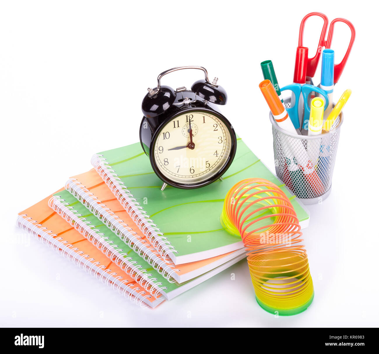 Pile of writing-book and alarm clock Stock Photo - Alamy