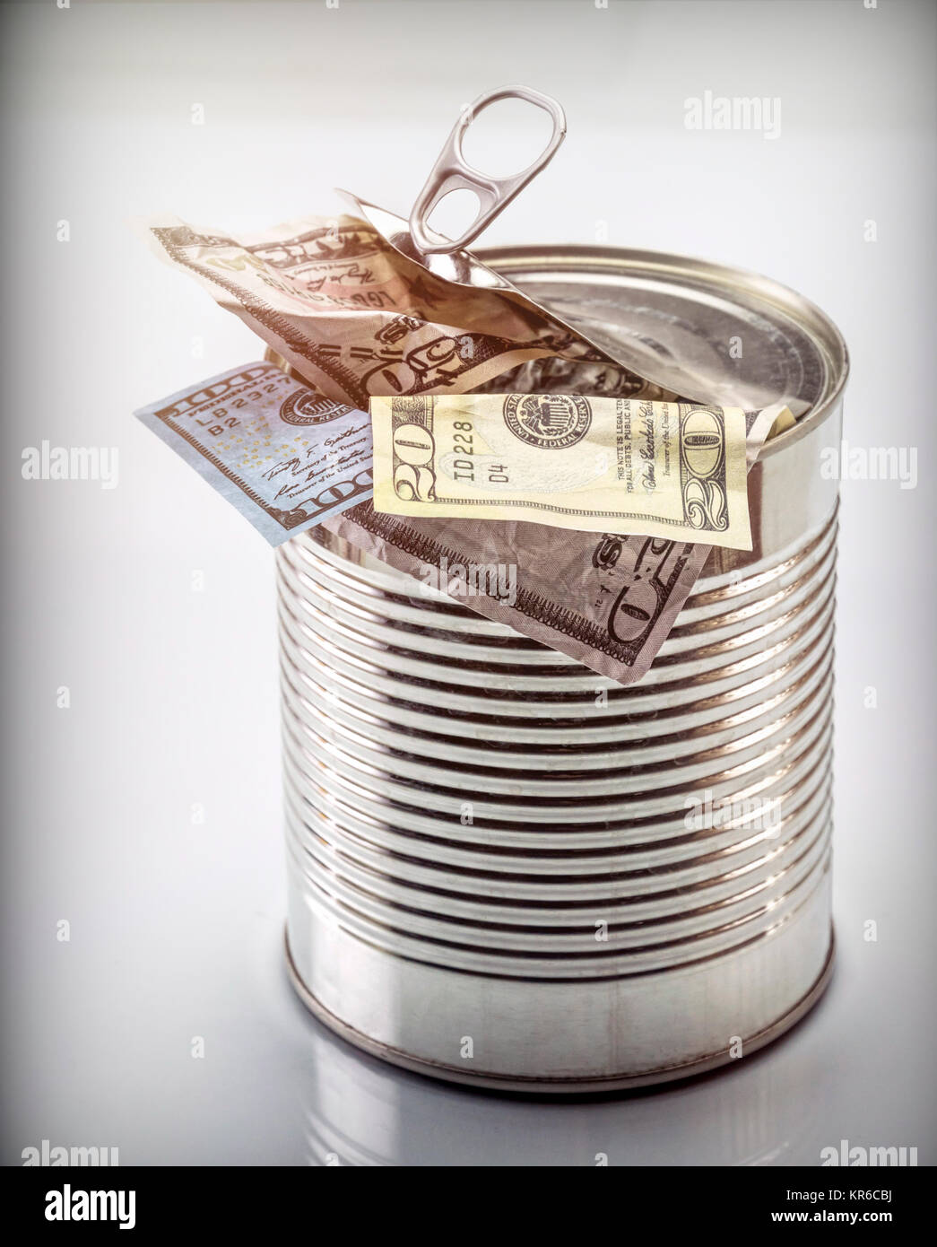 Canned cans full of dollar bills, conceptual image isolated on white ...