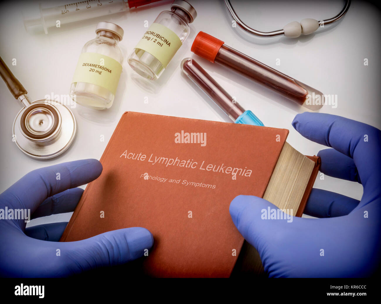 Doctor holds in its hands a book on the Acute lymphatic leukemia ...