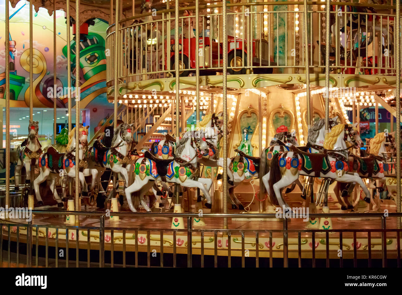 Circular children's carousel with colorful horses and cars Stock Photo ...