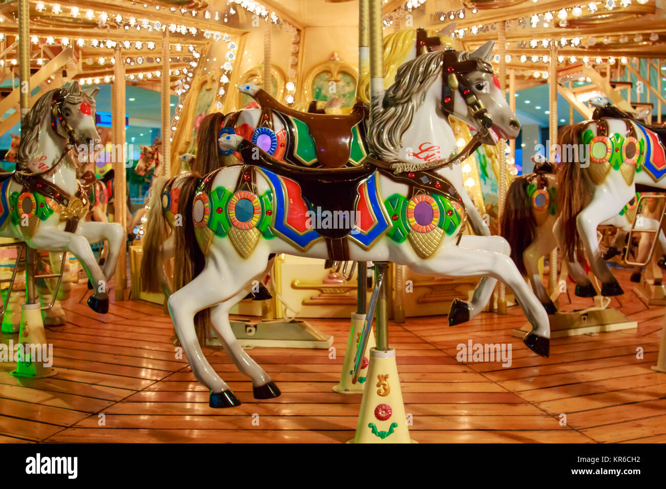 Children's merry-go-round in an amusement park with colorful horses ...