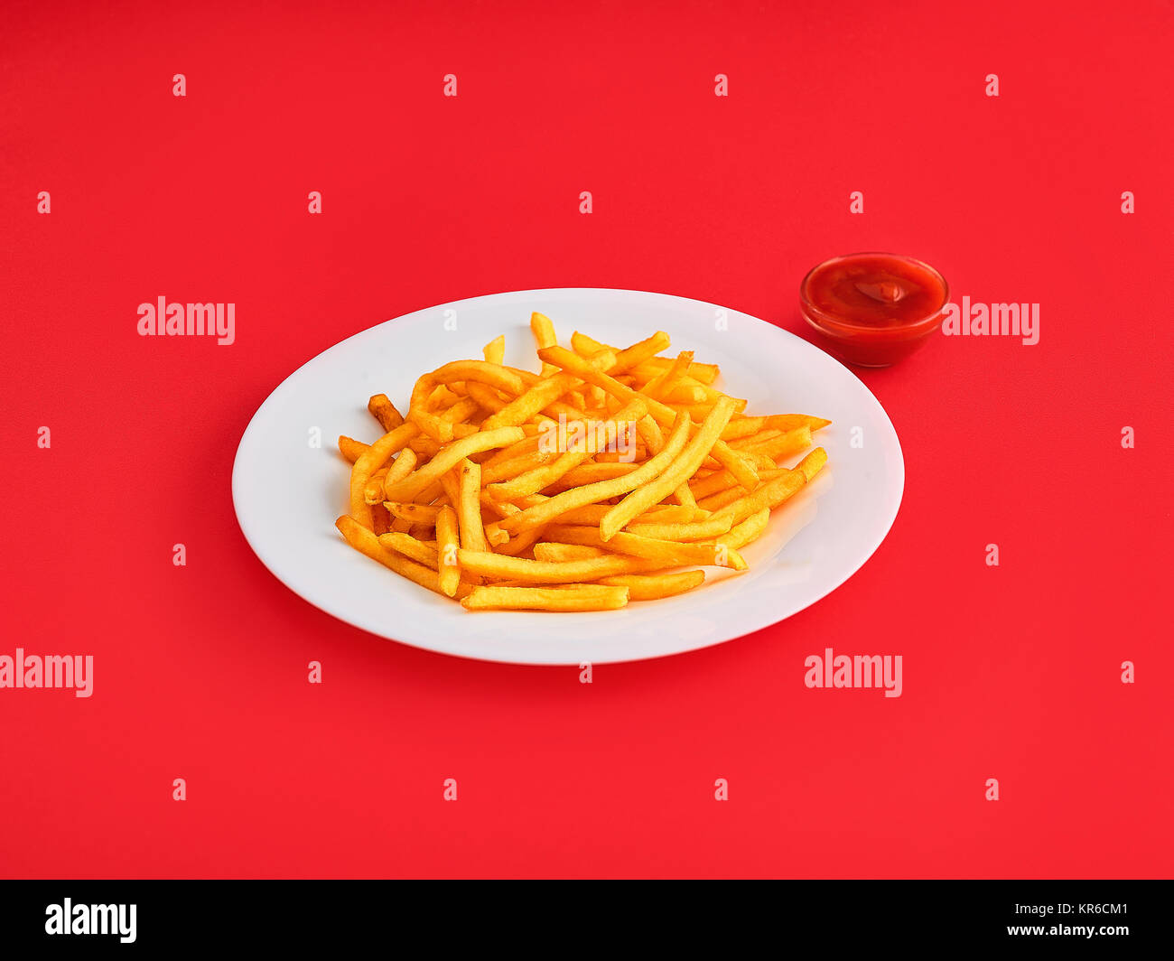French fries on a plate, isolated on red background Stock Photo - Alamy
