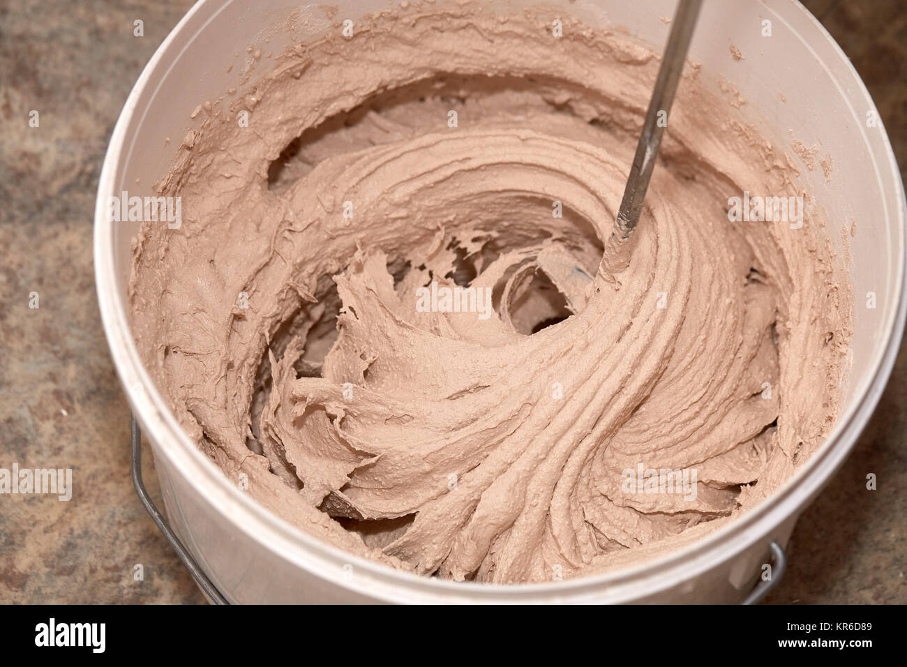 Mixing of a plaster solution by an electric drill Stock Photo - Alamy