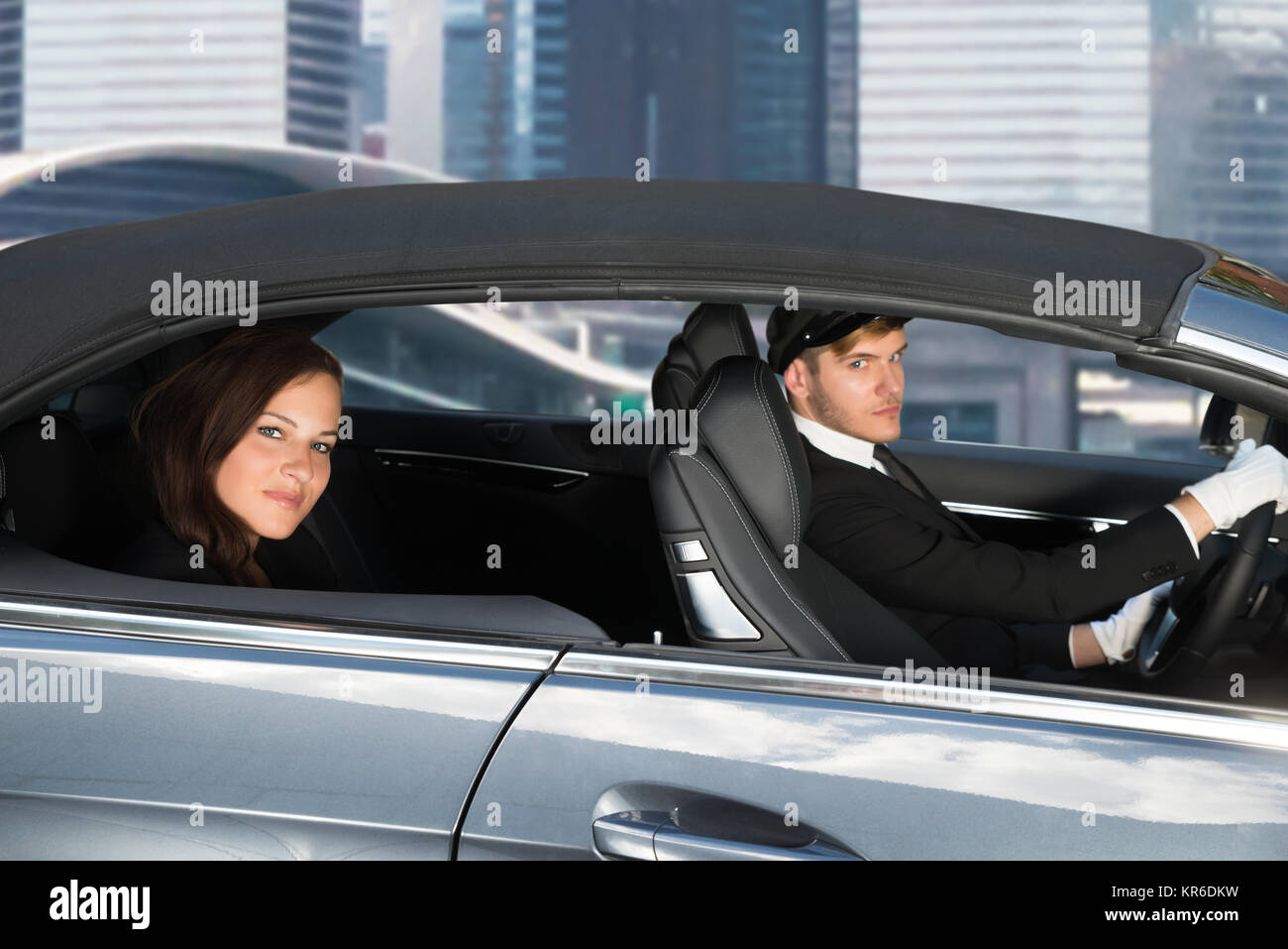 Young Woman Riding In A Car With Chauffeur Stock Photo - Alamy