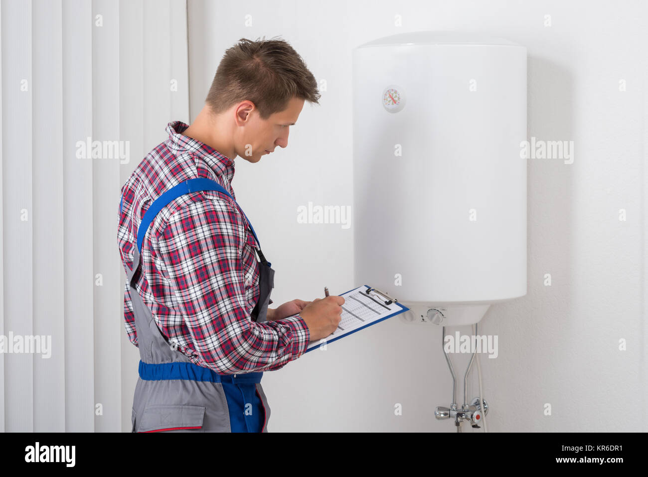 Plumber Checking Electric Boiler Stock Photo - Alamy
