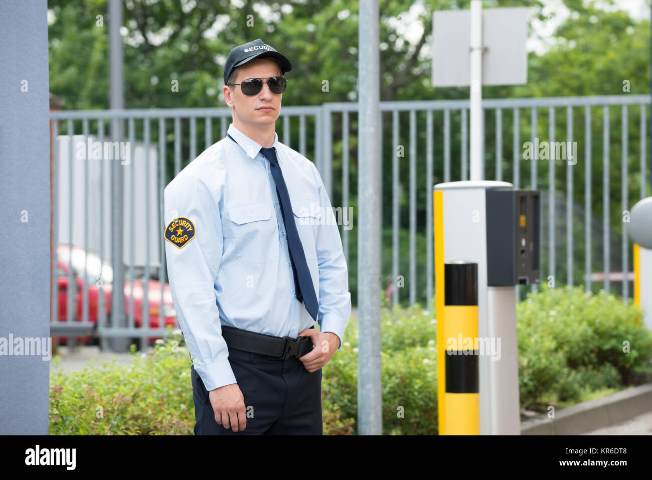 Security Guard Standing Beside Car Parking Machine Stock Photo - Alamy
