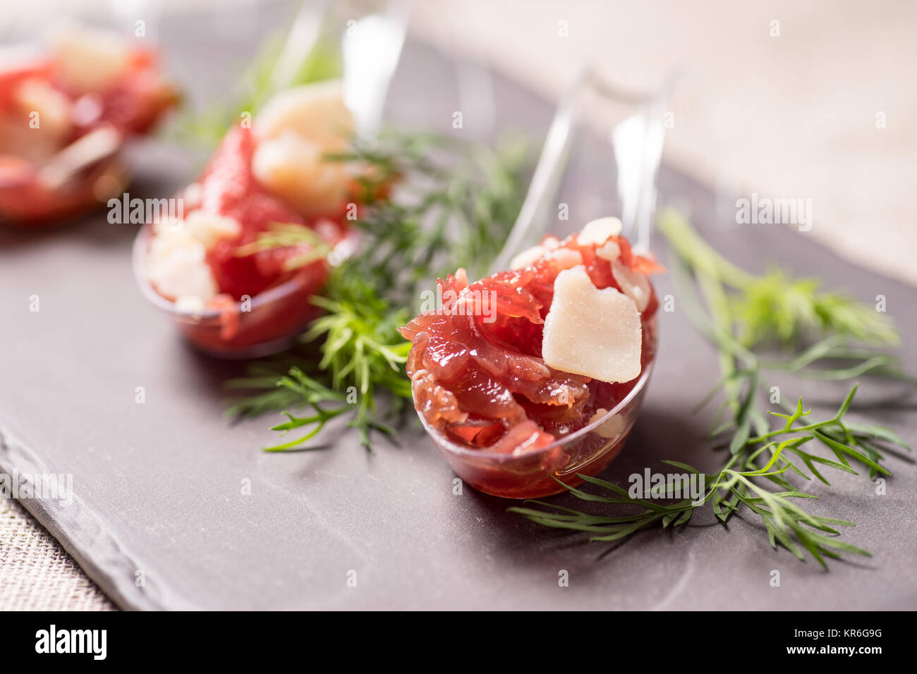 Appetizer with meat, Carpaccio and parmesan served on a Spoon Stock ...