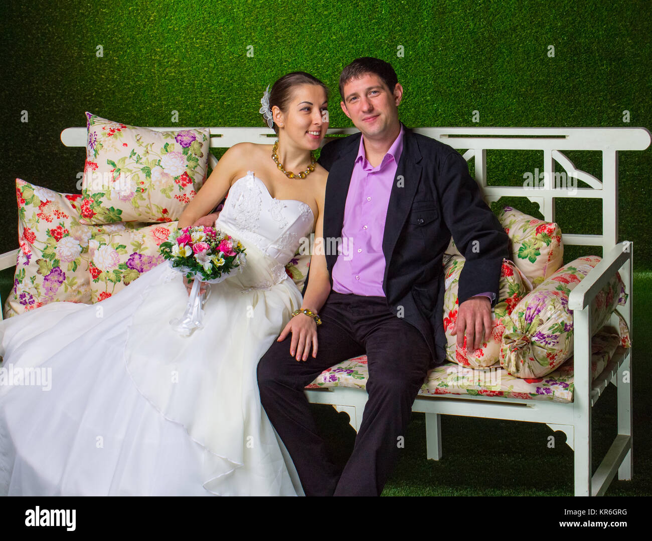 Bride and groom sitting together on a bench Stock Photo - Alamy