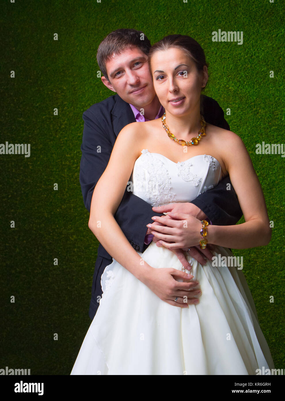 Happy pregnant bride and groom embracing belly together Stock Photo - Alamy