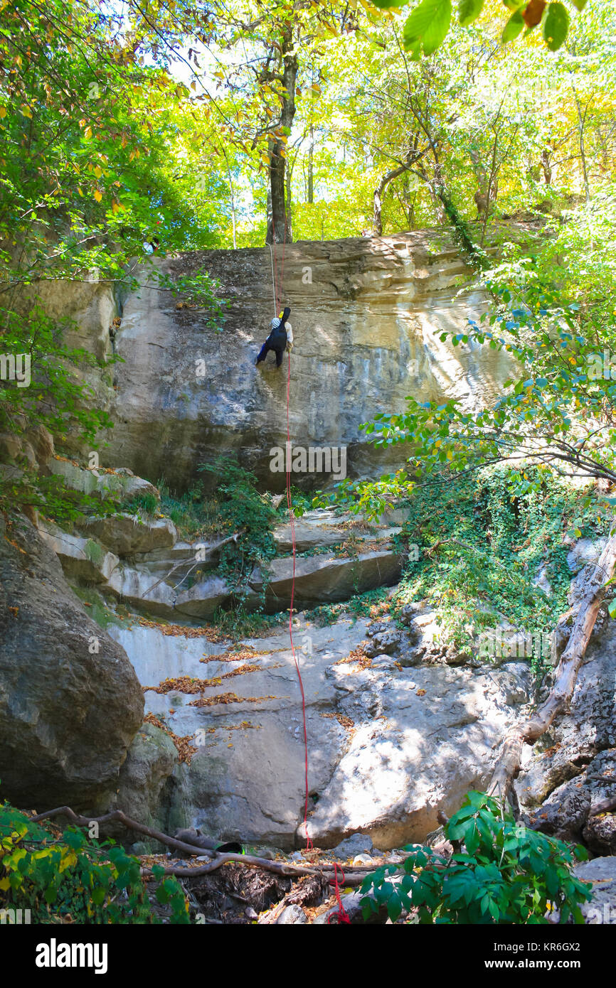 Woman climbing on steep the mountain slope Stock Photo - Alamy