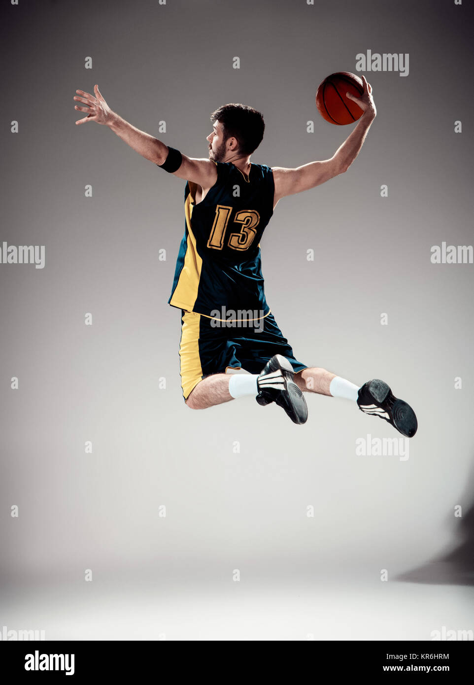 Full length portrait of a basketball player with ball Stock Photo - Alamy