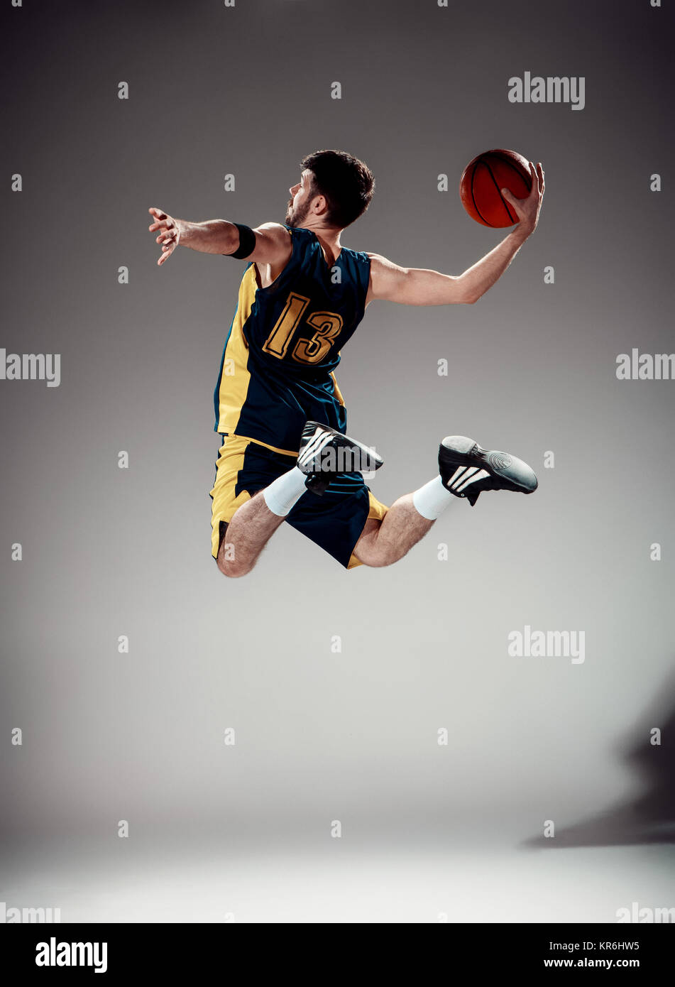 Full length portrait of a basketball player with ball Stock Photo - Alamy
