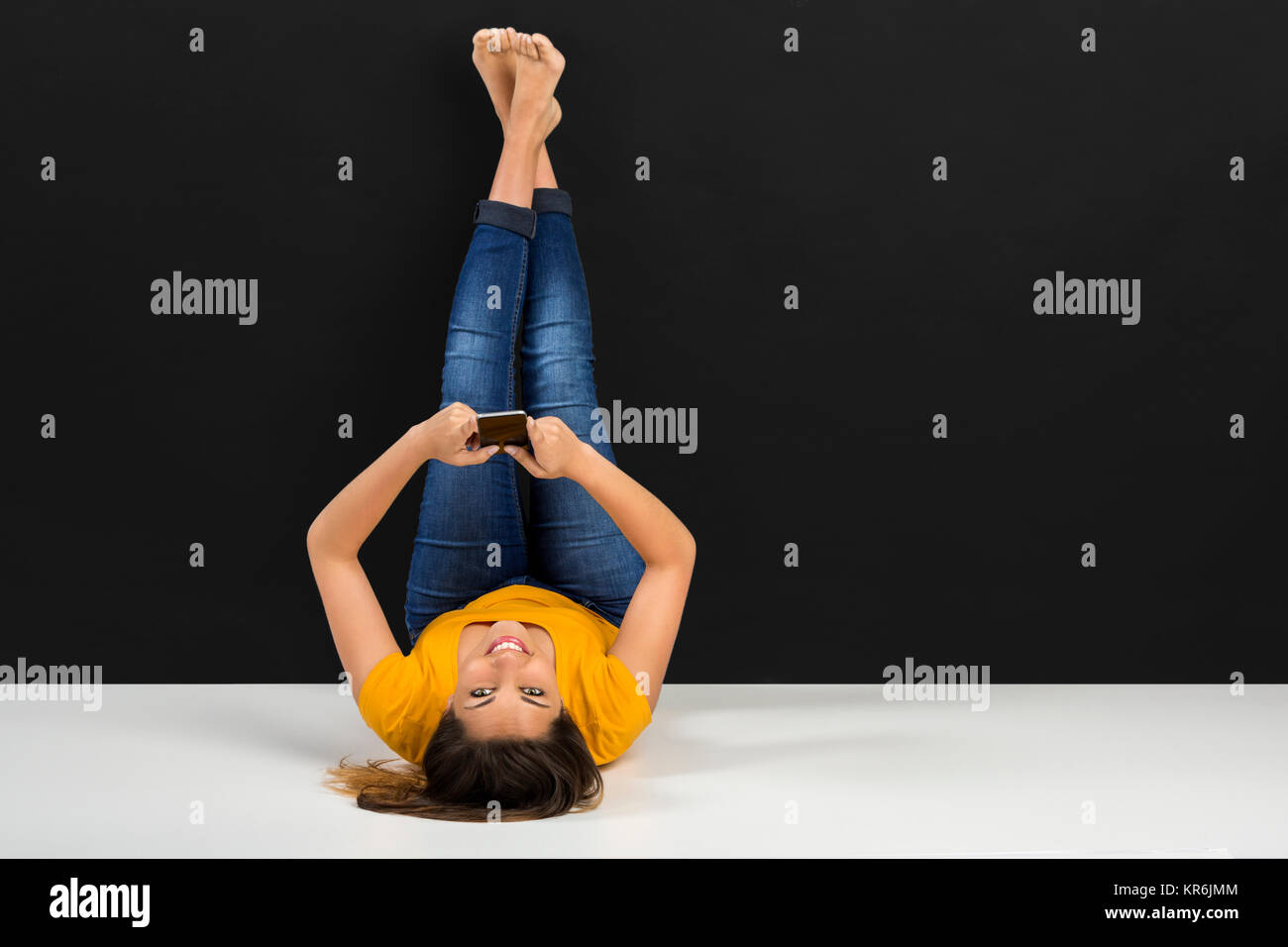 Happy girl texting Stock Photo - Alamy