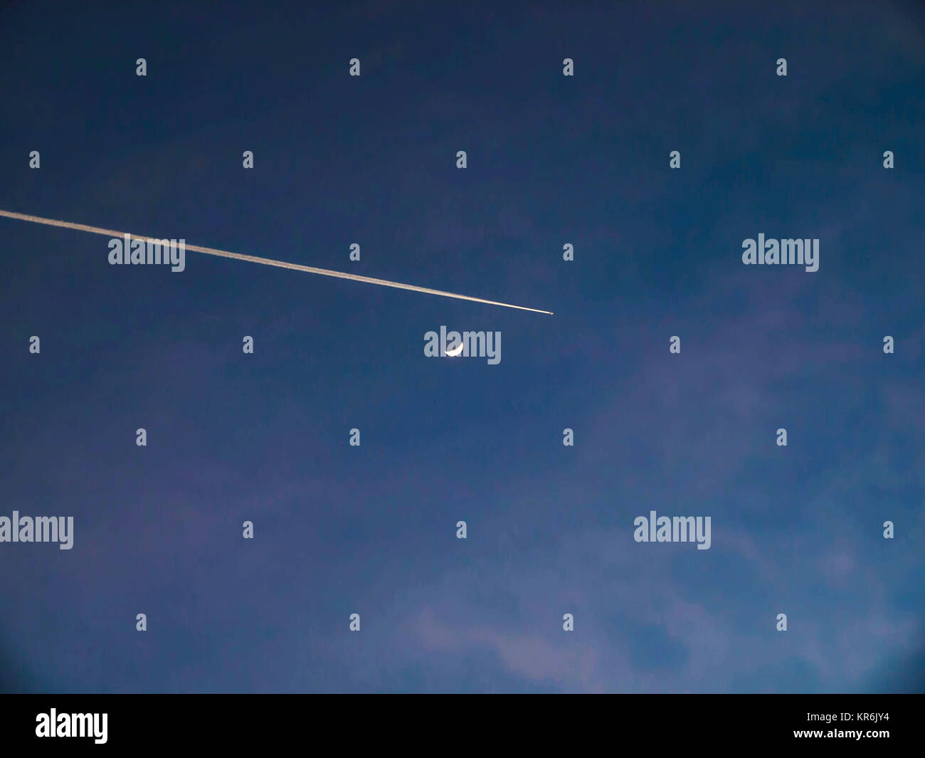 A jet passing near the moon Stock Photo - Alamy