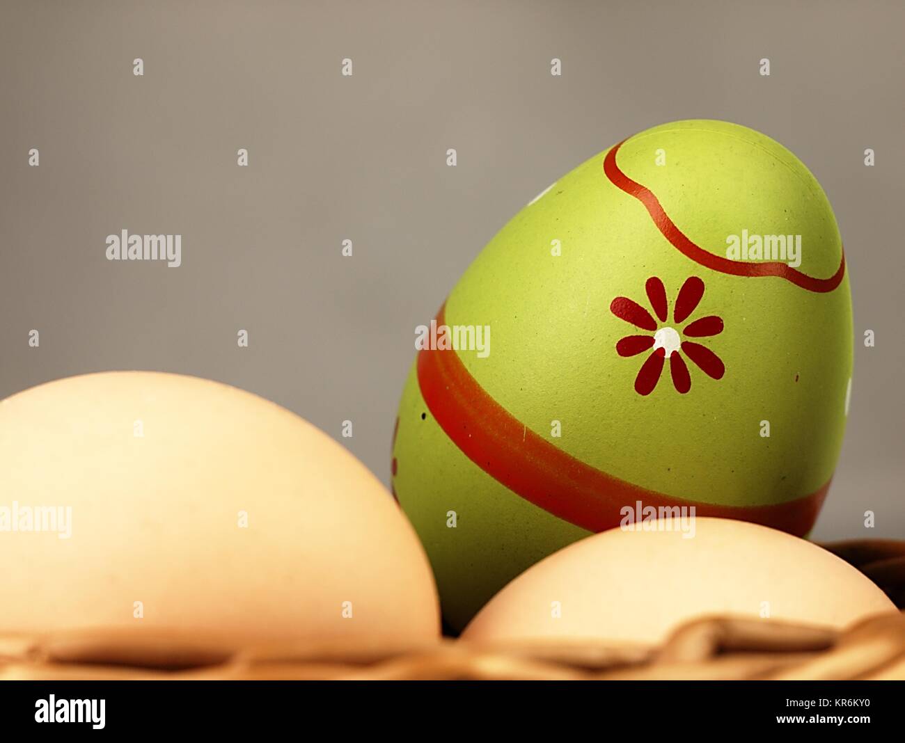 Colorful Easter egg in the company of ordinary eggs Stock Photo - Alamy