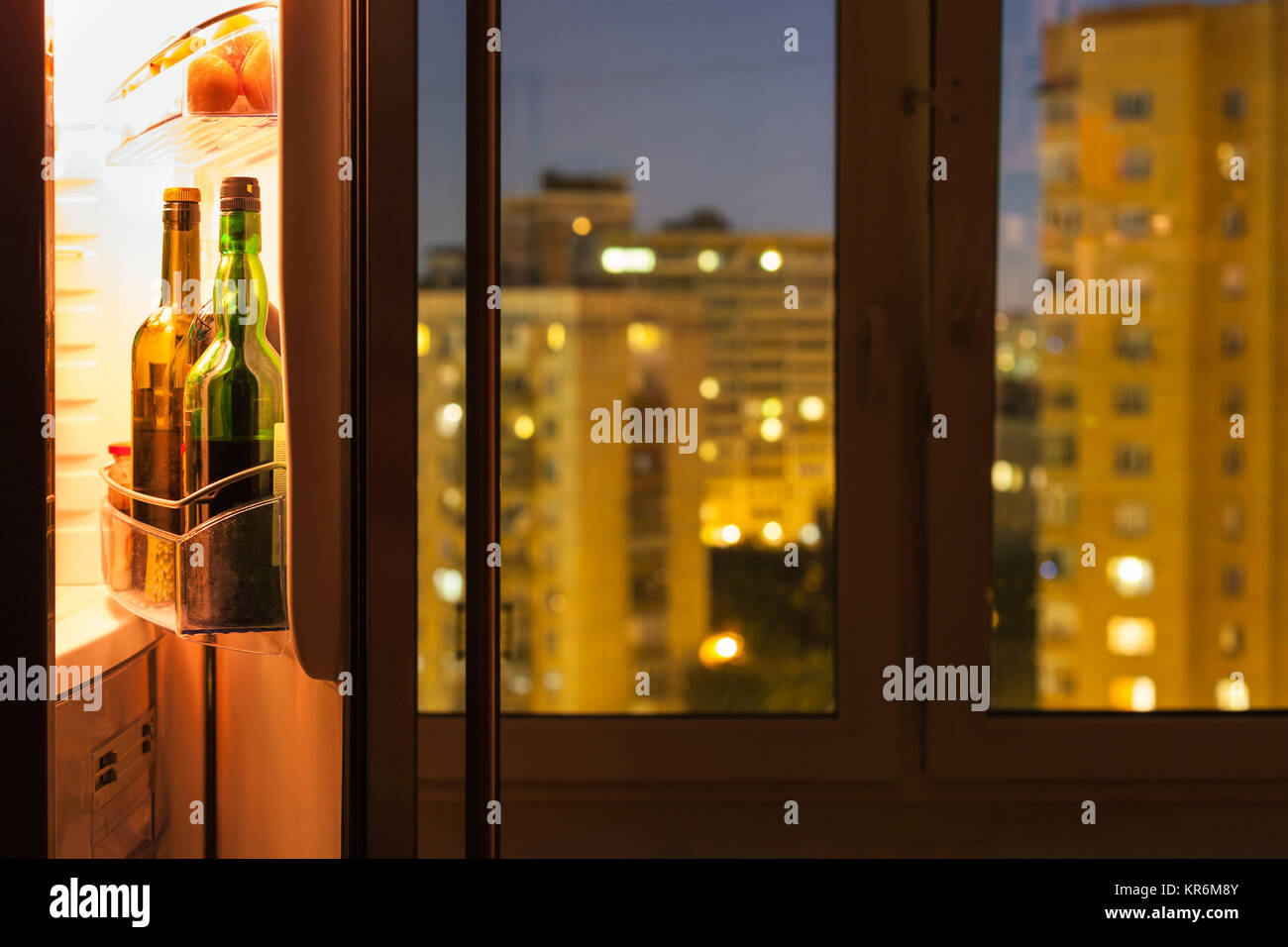 Open refrigerator with bottles in night Stock Photo - Alamy