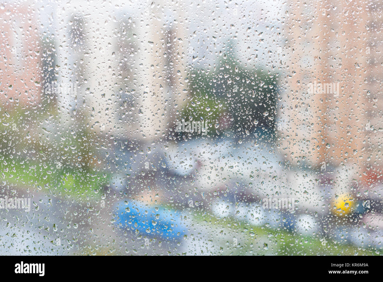 view of raindrops on windowpane of urban house Stock Photo - Alamy