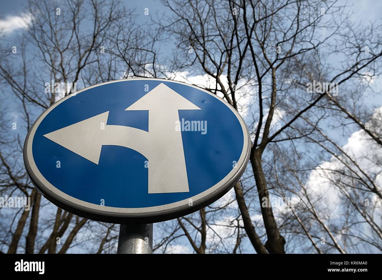 Fork road warning sign Stock Photo - Alamy