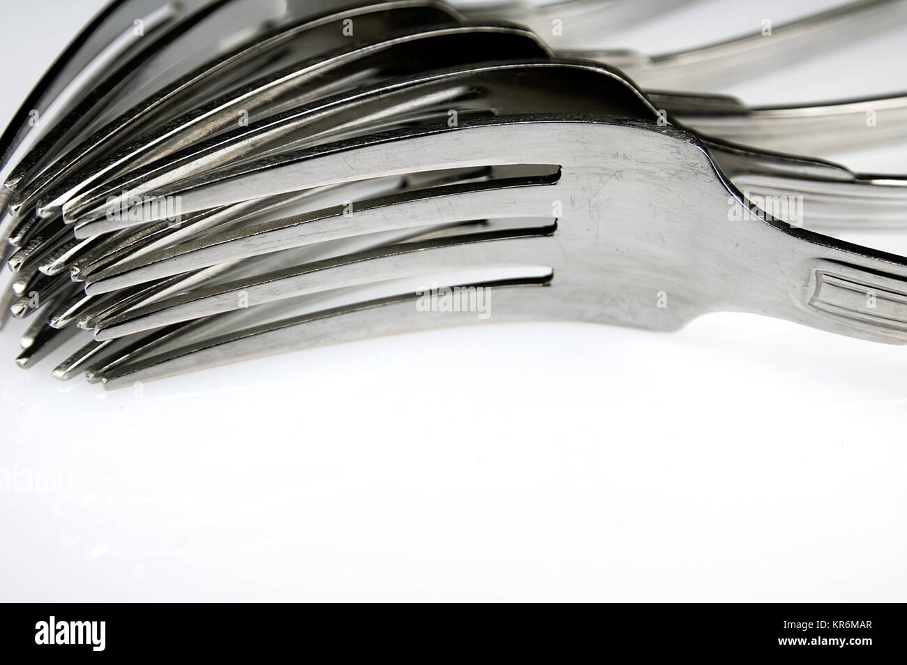 Forks arranged in series on the kitchen table Stock Photo - Alamy