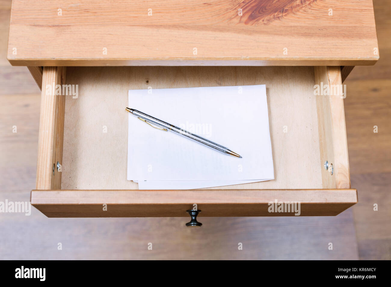 folded note and pen in open drawer Stock Photo - Alamy