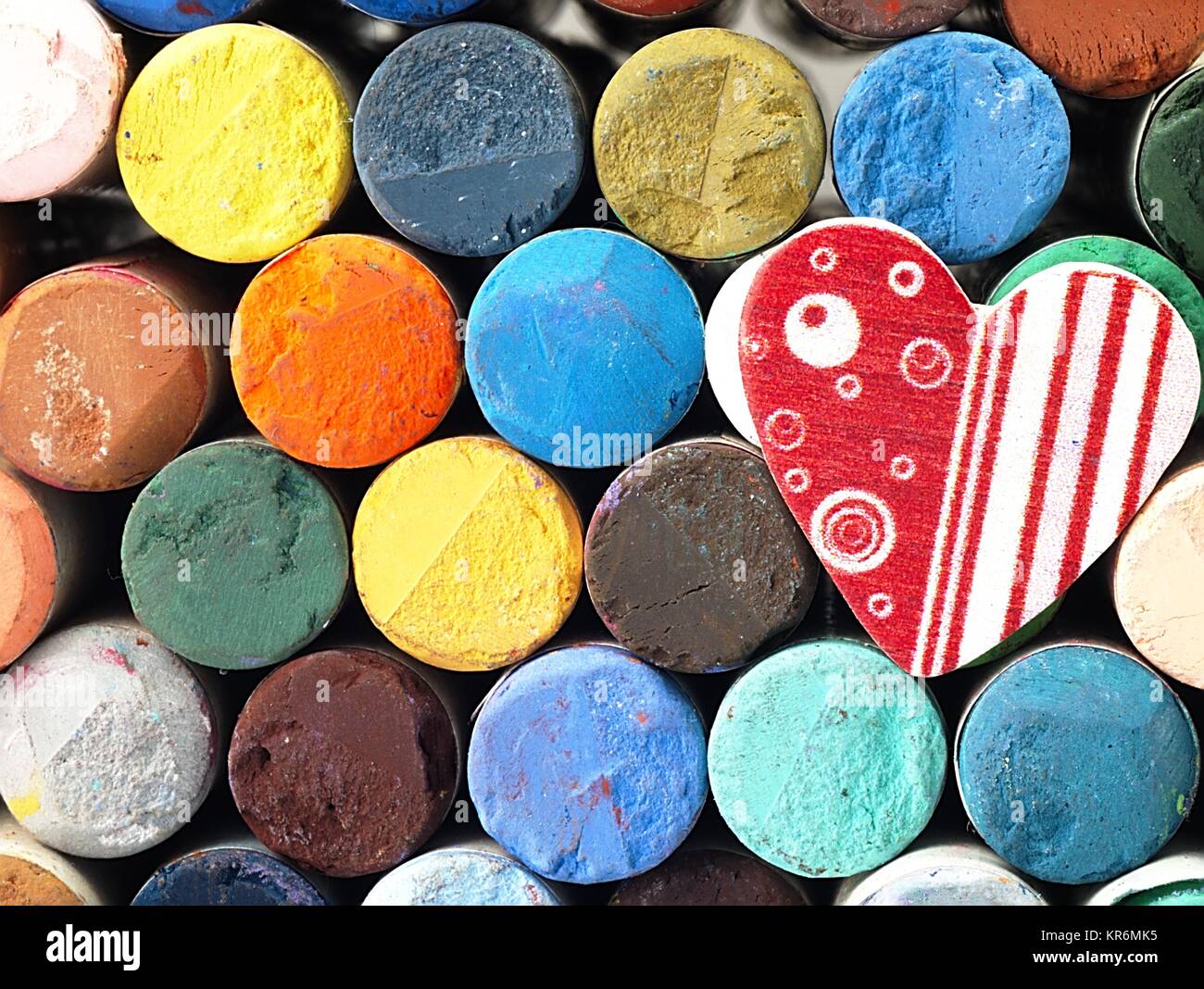 Heart and colored dry pastels closely Stock Photo - Alamy