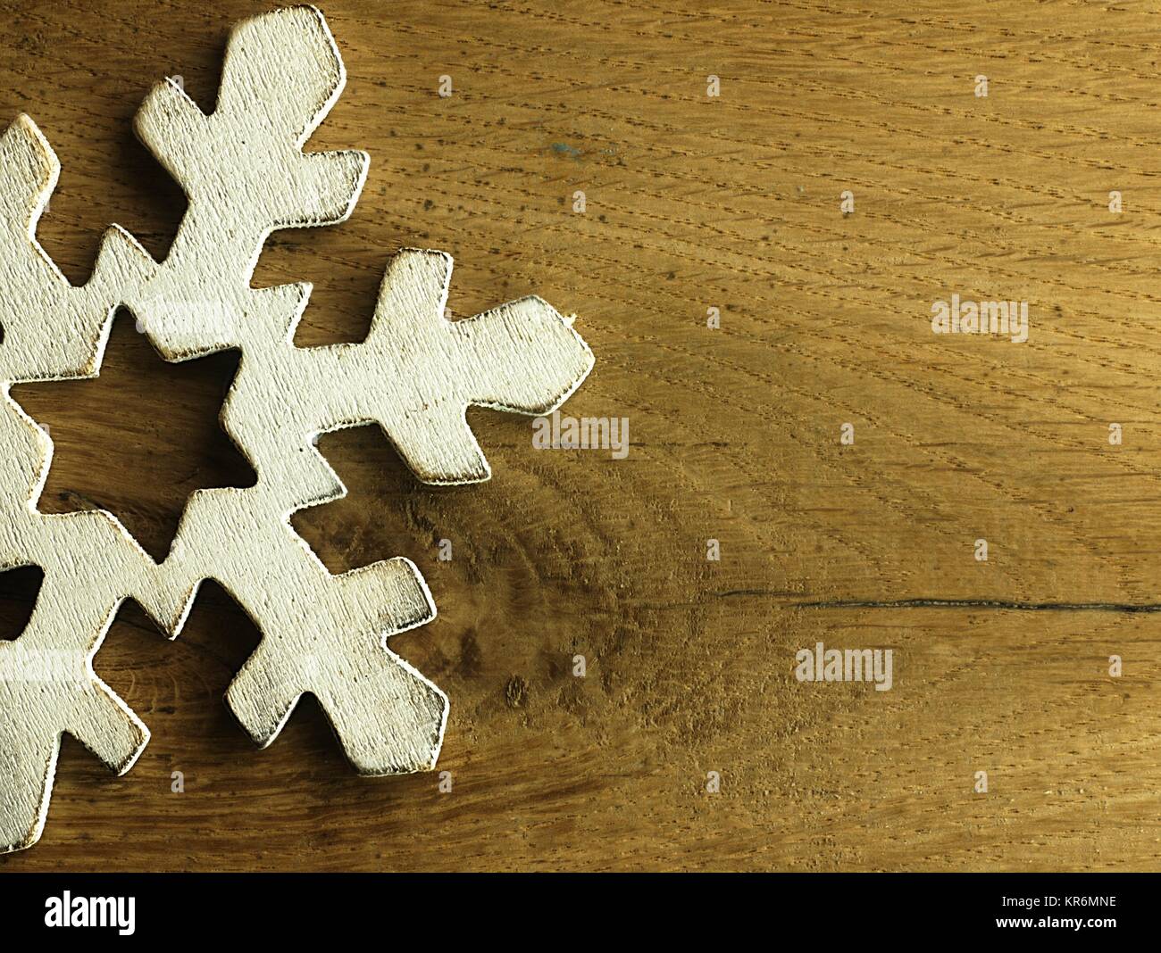 Huge white snowflake and wooden background Stock Photo - Alamy