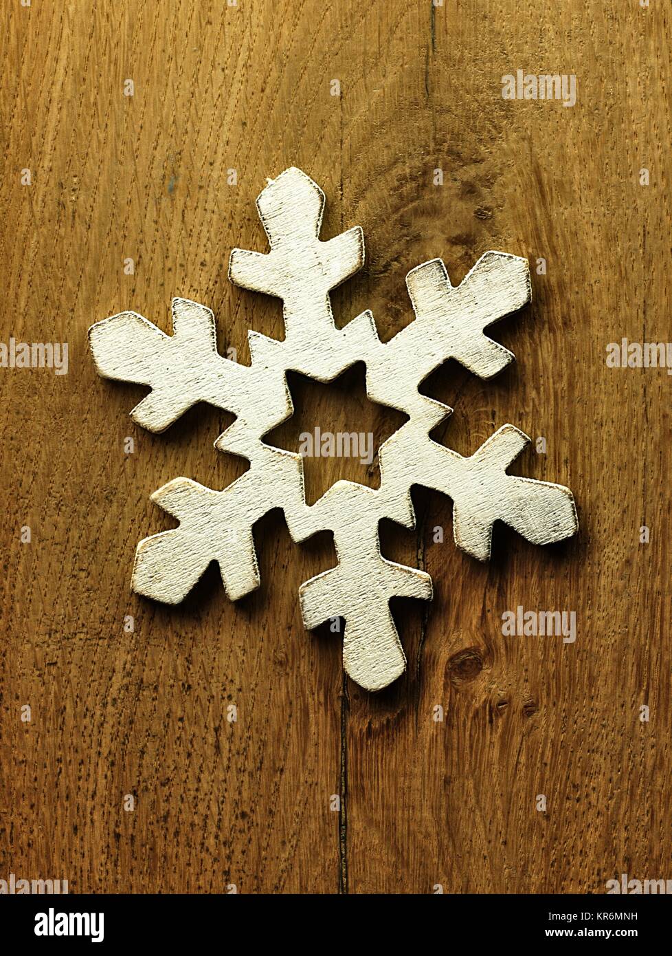 Huge white snowflake and wooden background Stock Photo - Alamy