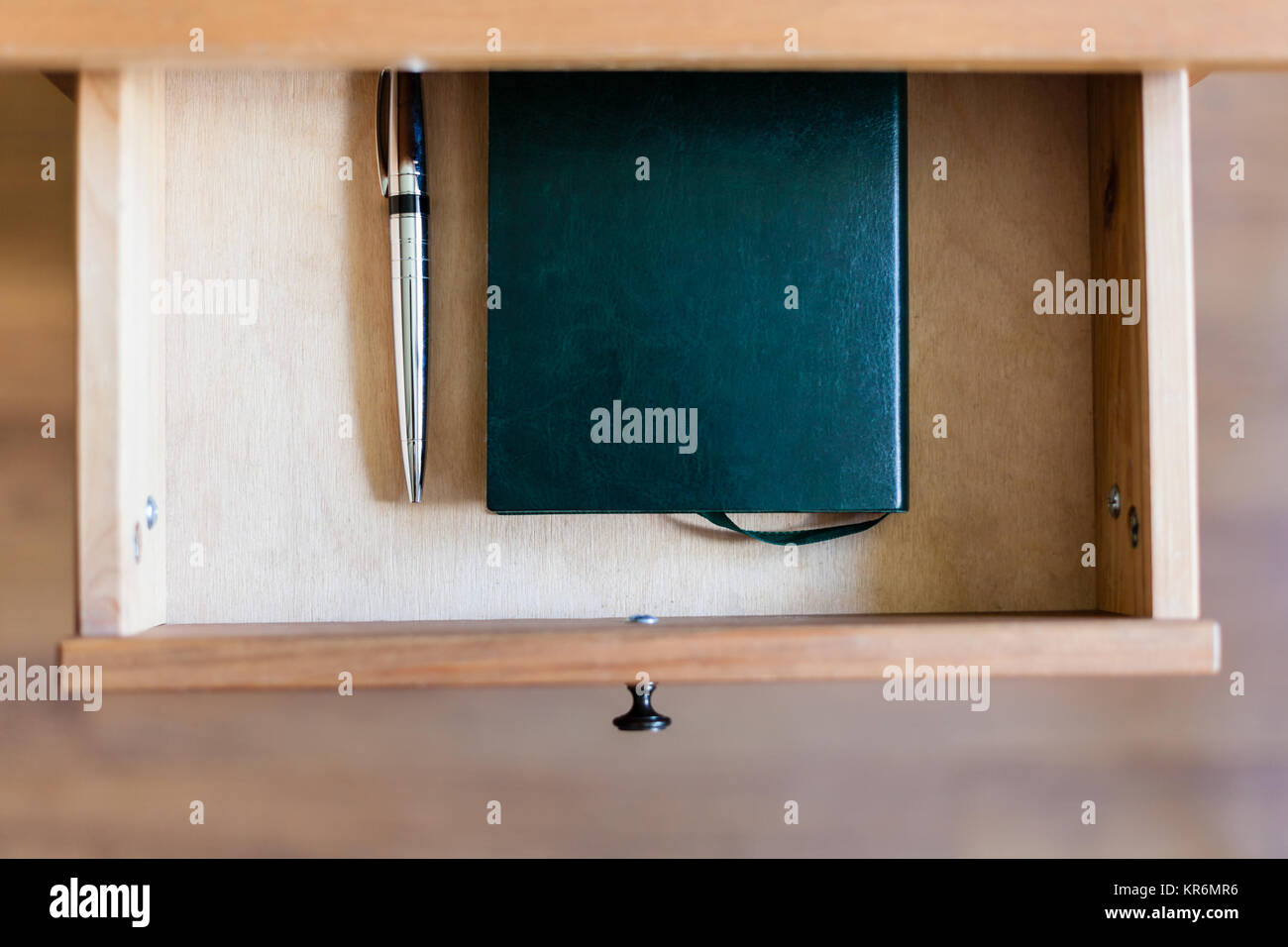 pen and notebook in open drawer Stock Photo - Alamy