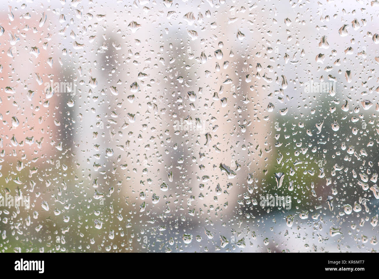 Raindrops flow down window glass hi-res stock photography and images ...
