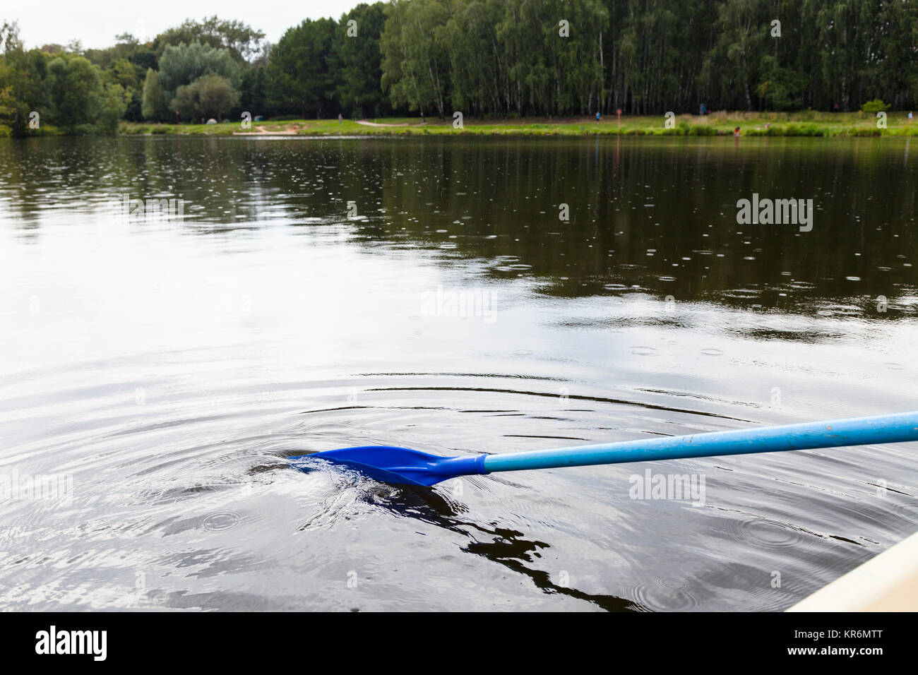 float on boat with oars in city pond Stock Photo - Alamy