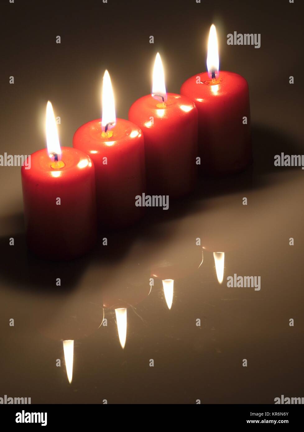 Red candles reflecting in the mirror surface Stock Photo - Alamy