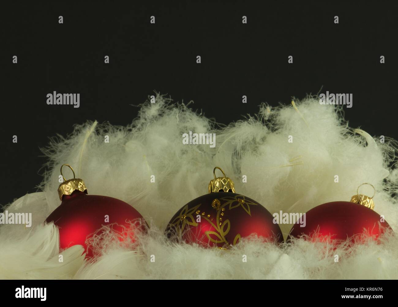 Red Christmas balls mixed with white feathers Stock Photo - Alamy