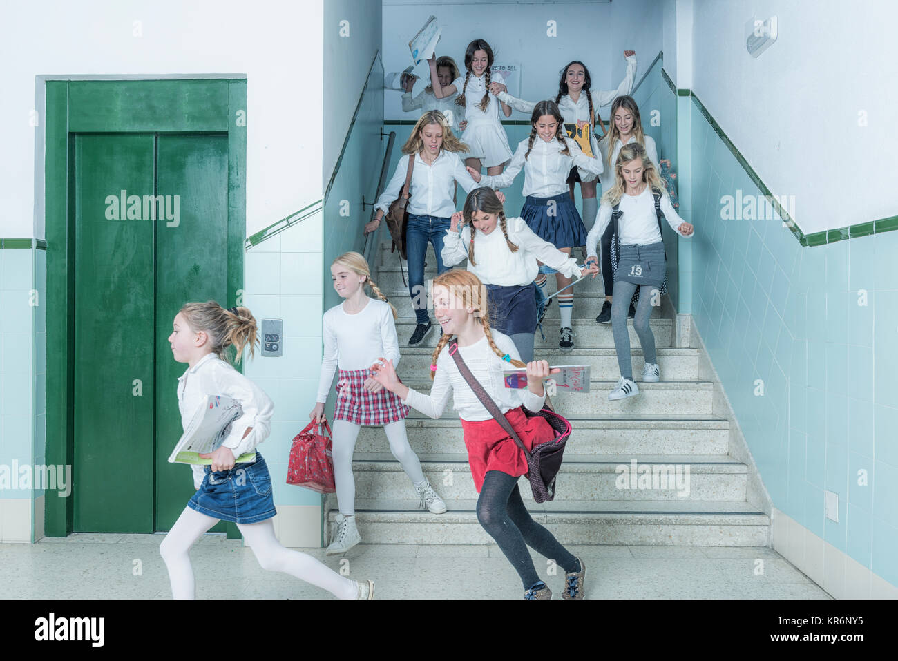 Kids rushing down the stairs after class Stock Photo - Alamy