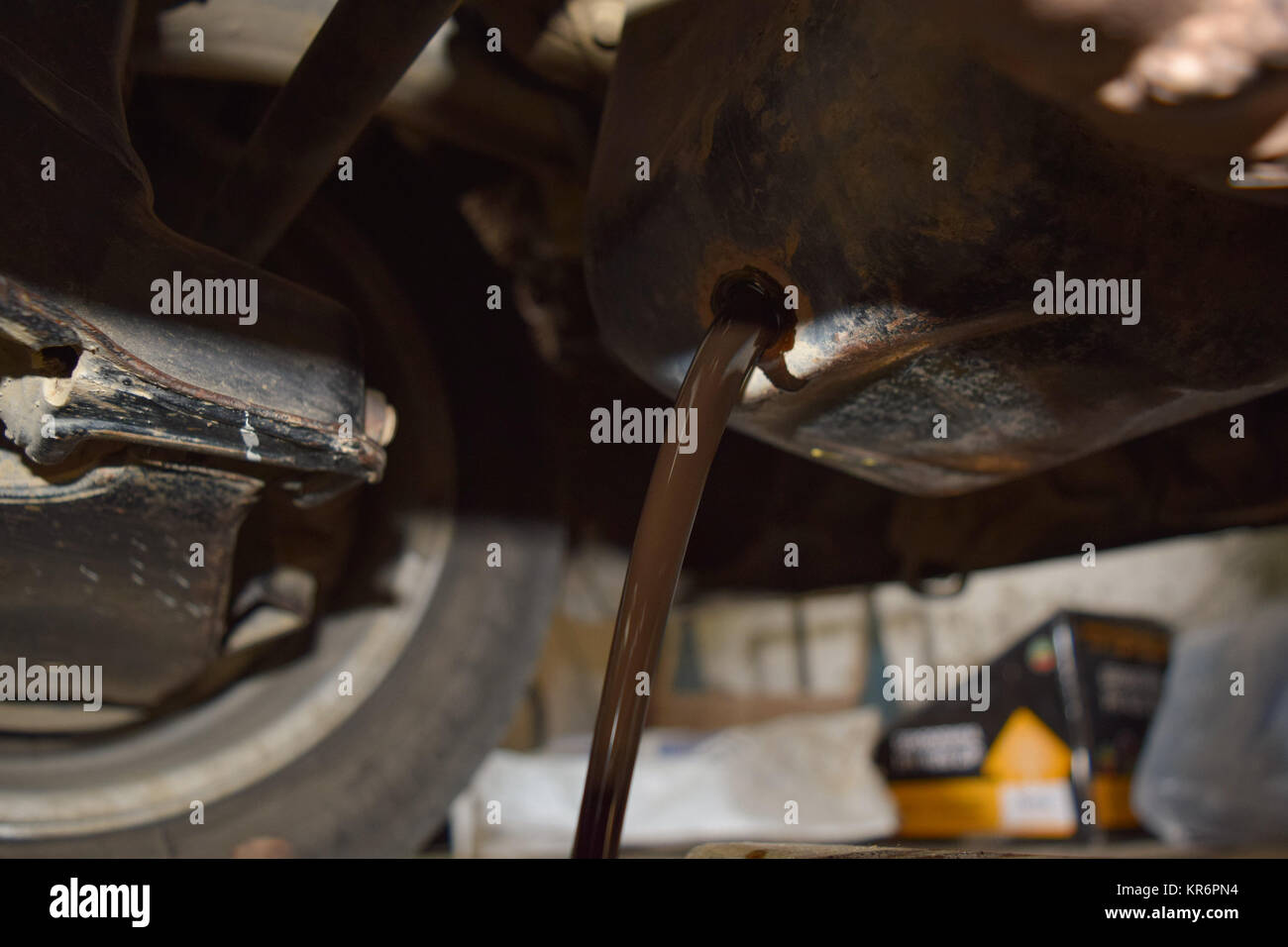 Drain the old oil from the engine through the drain plug Stock Photo ...