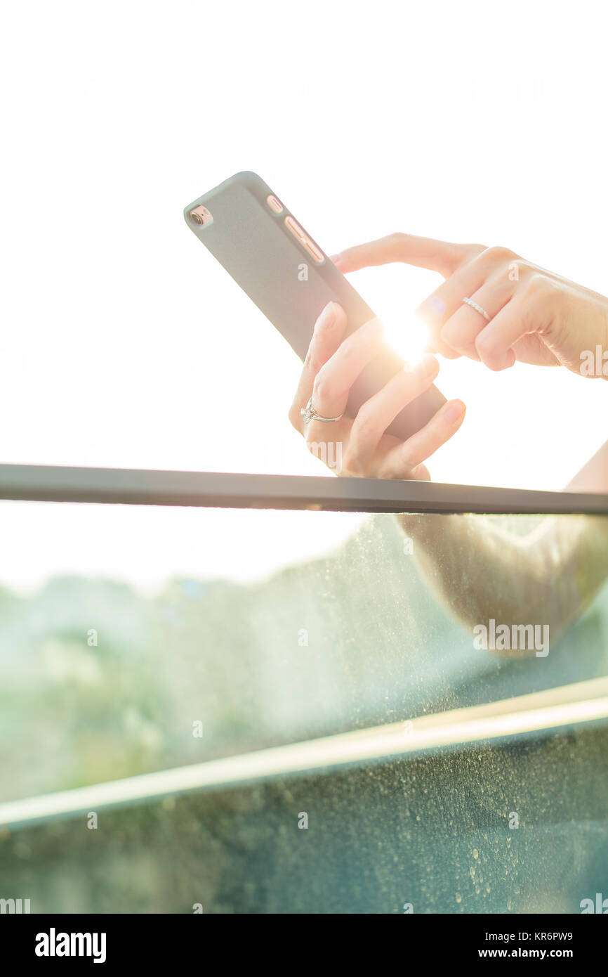 Using mobile phone at outdoor Stock Photo - Alamy