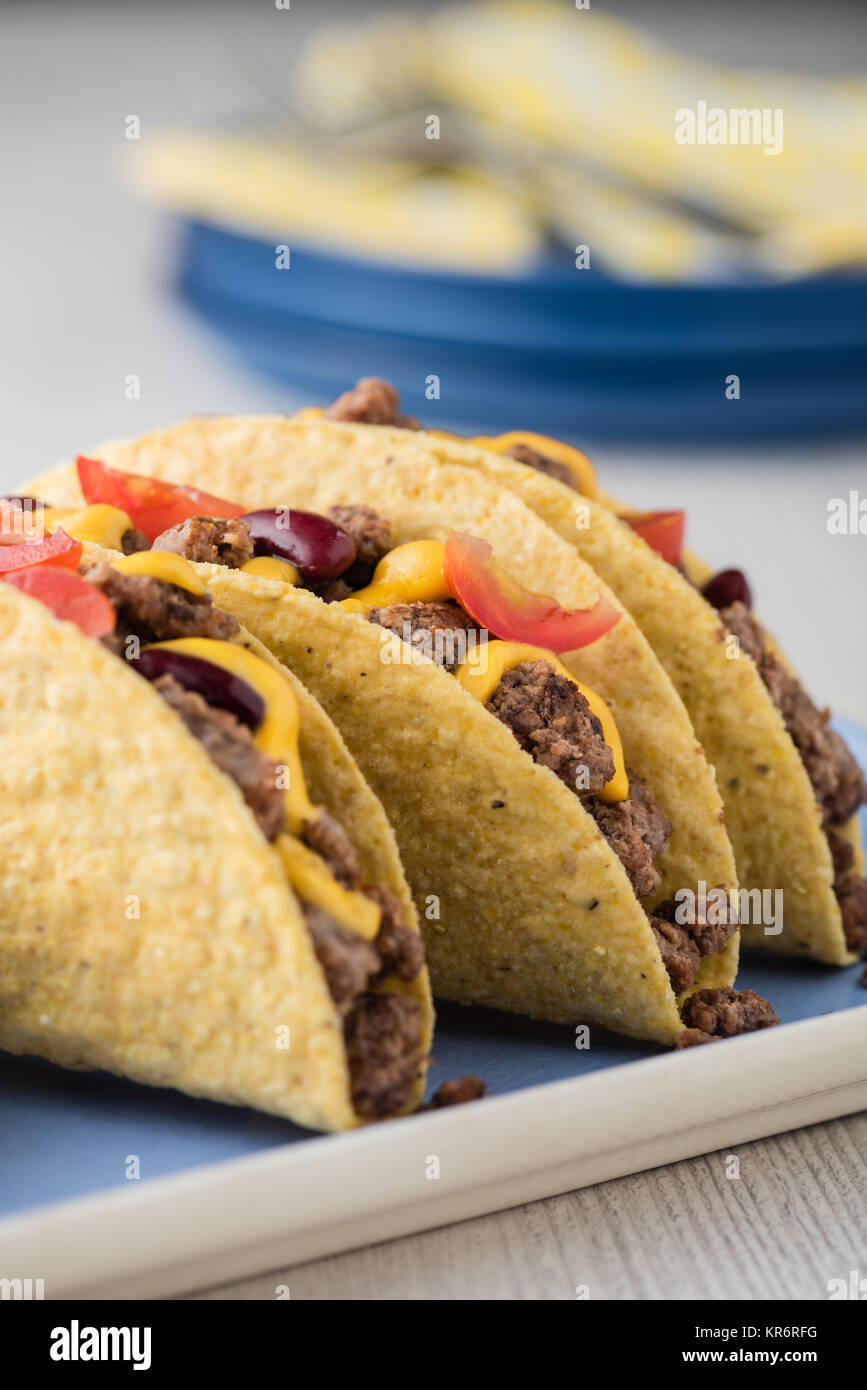 Mexican tacos with beef, cheddar cheese, tomato Stock Photo - Alamy