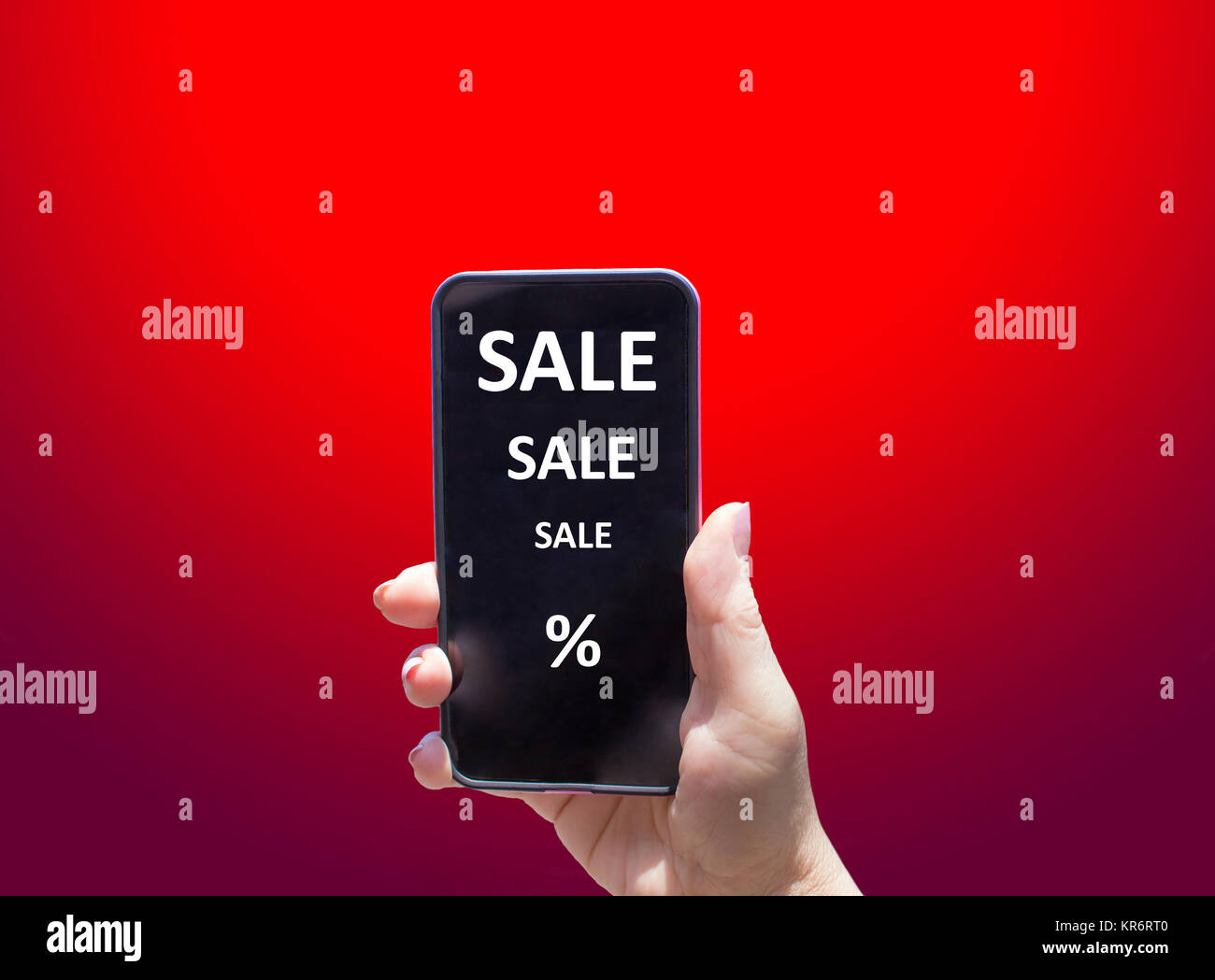The phone with text SALE in female hand on the red background Stock ...