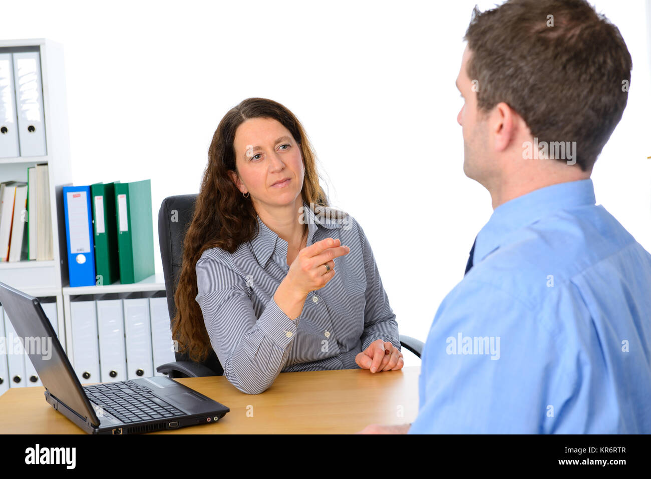 angry female boss in serious conversation with clerk Stock Photo - Alamy