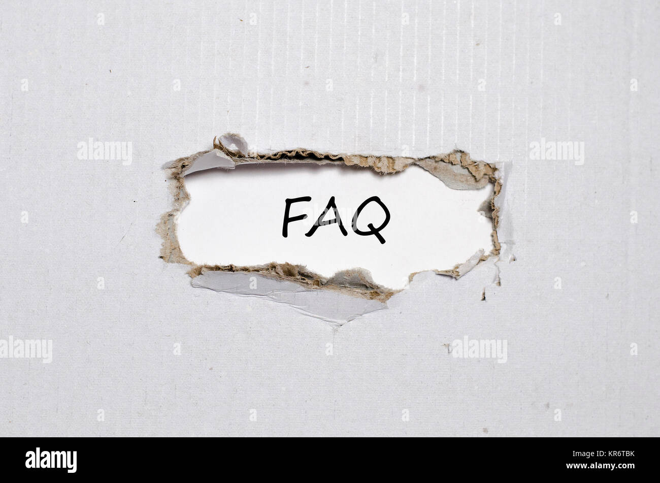 The word faq appearing behind torn paper Stock Photo - Alamy