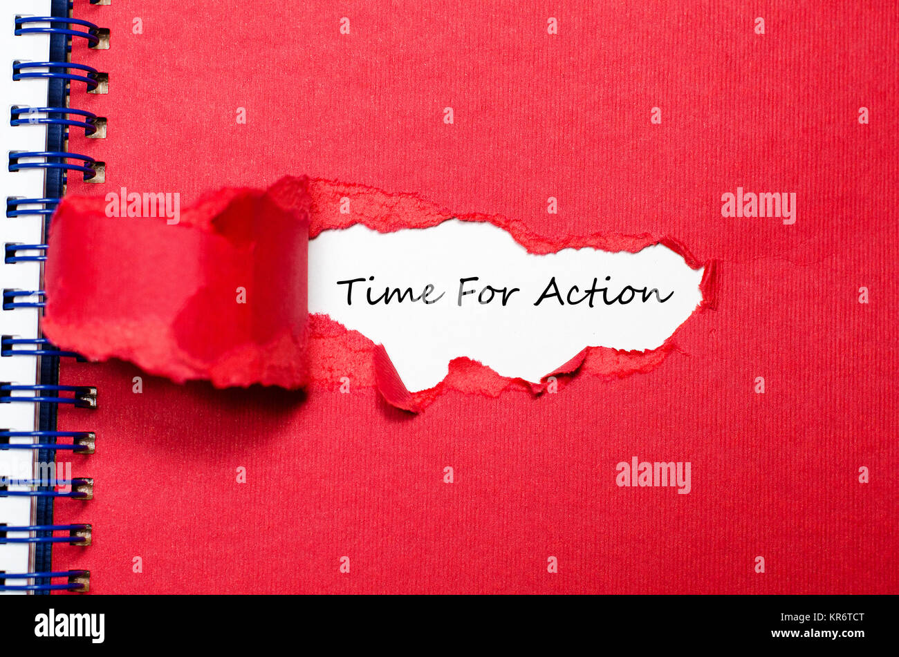 The word time for action appearing behind torn paper Stock Photo - Alamy