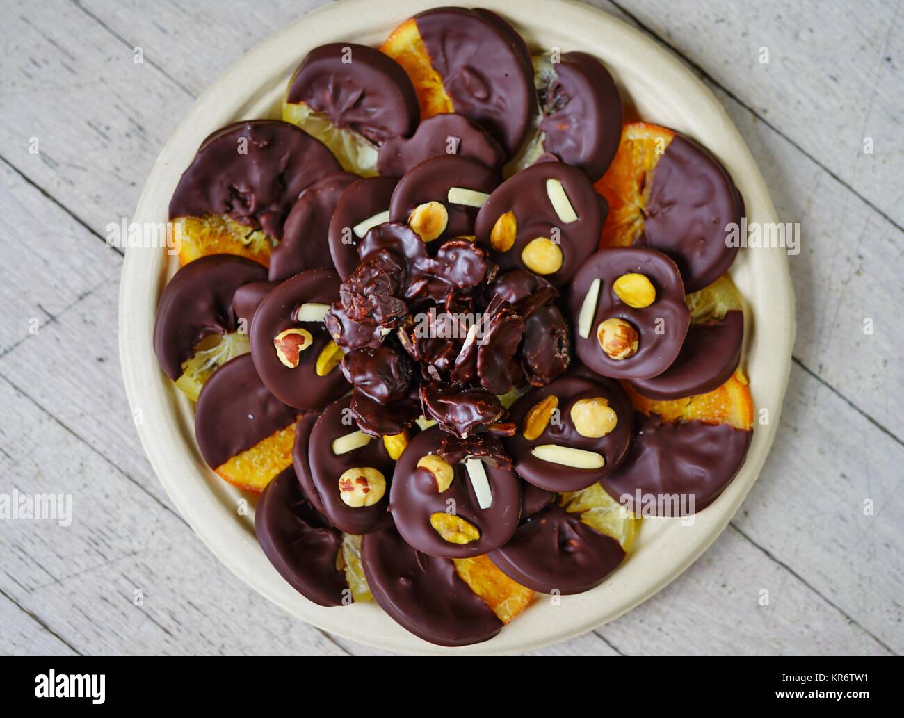 A plate of homemade chocolate candies including candied orange slices ...