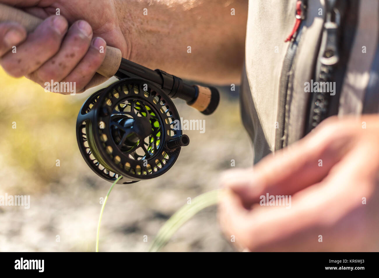Close up of fisherman holding his fishing rod Stock Photo - Alamy