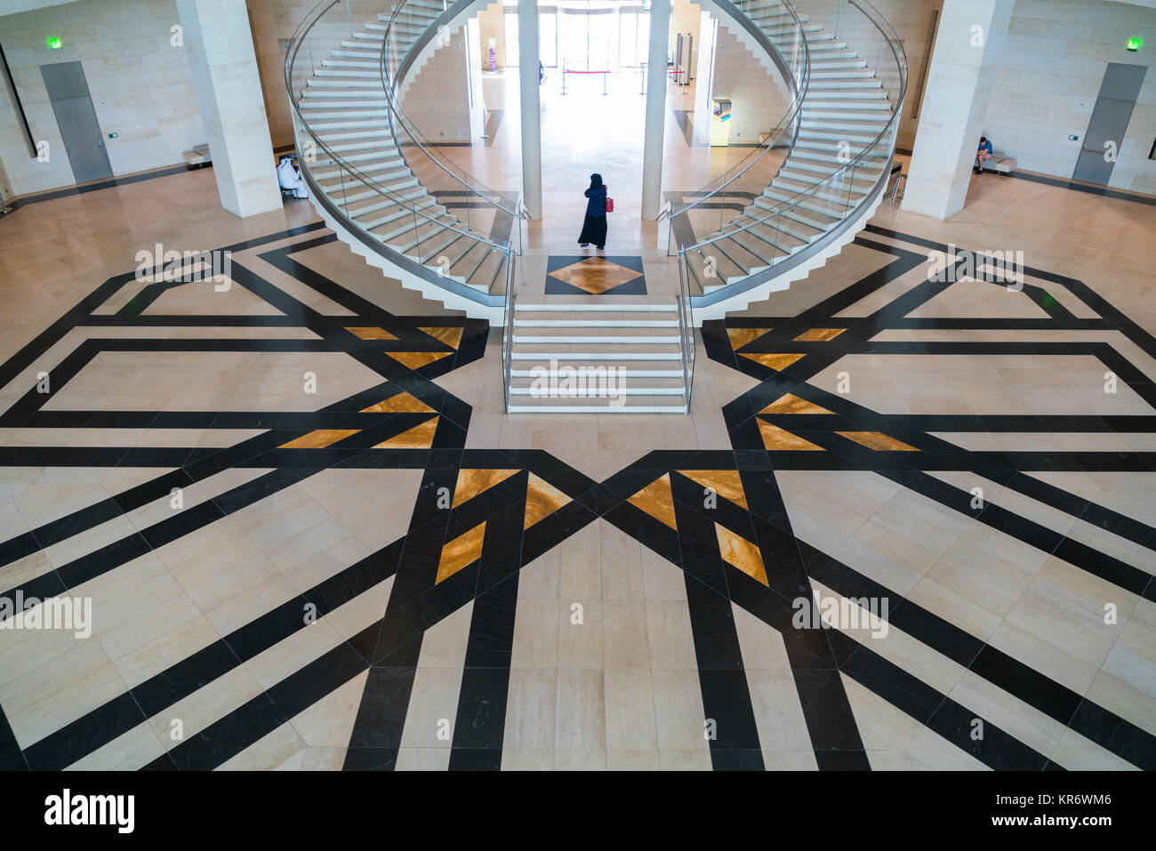 High angle view of building interior with curved freestanding staircase ...