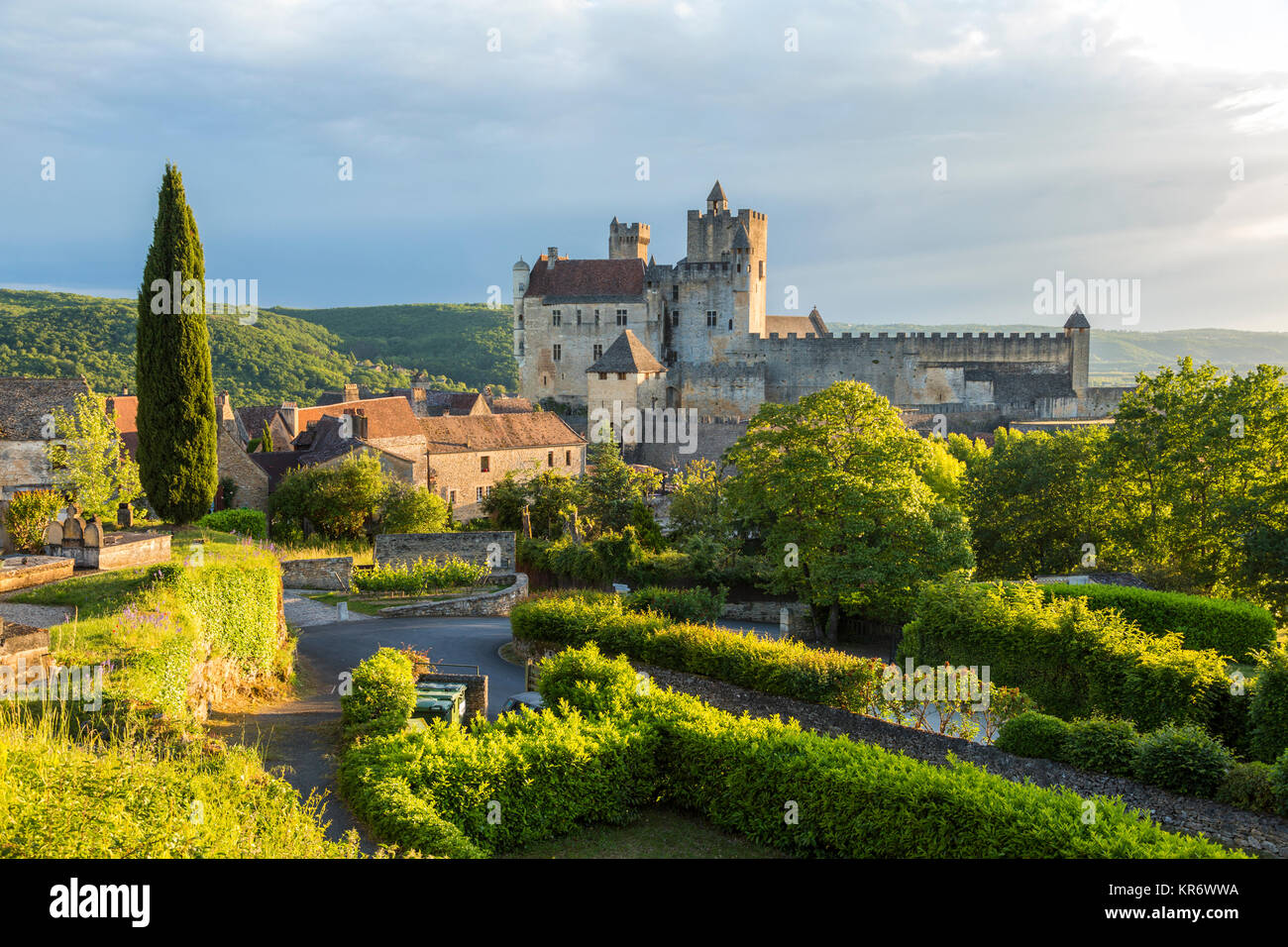 Landscape with trees, hedges and medieval castle with graveyard in the ...