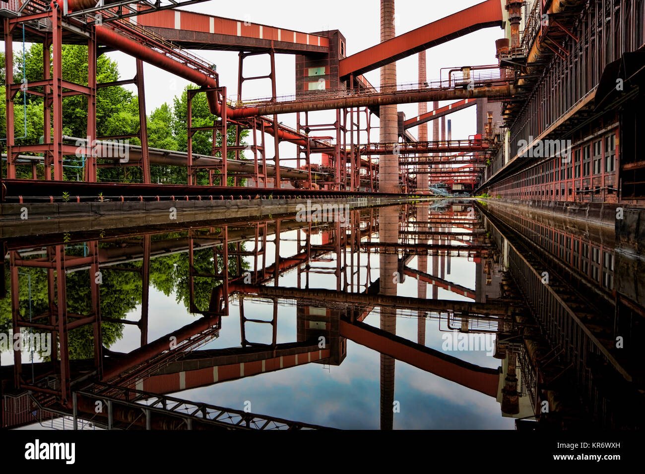 Industrial building with pipes and chimneys running across and ...
