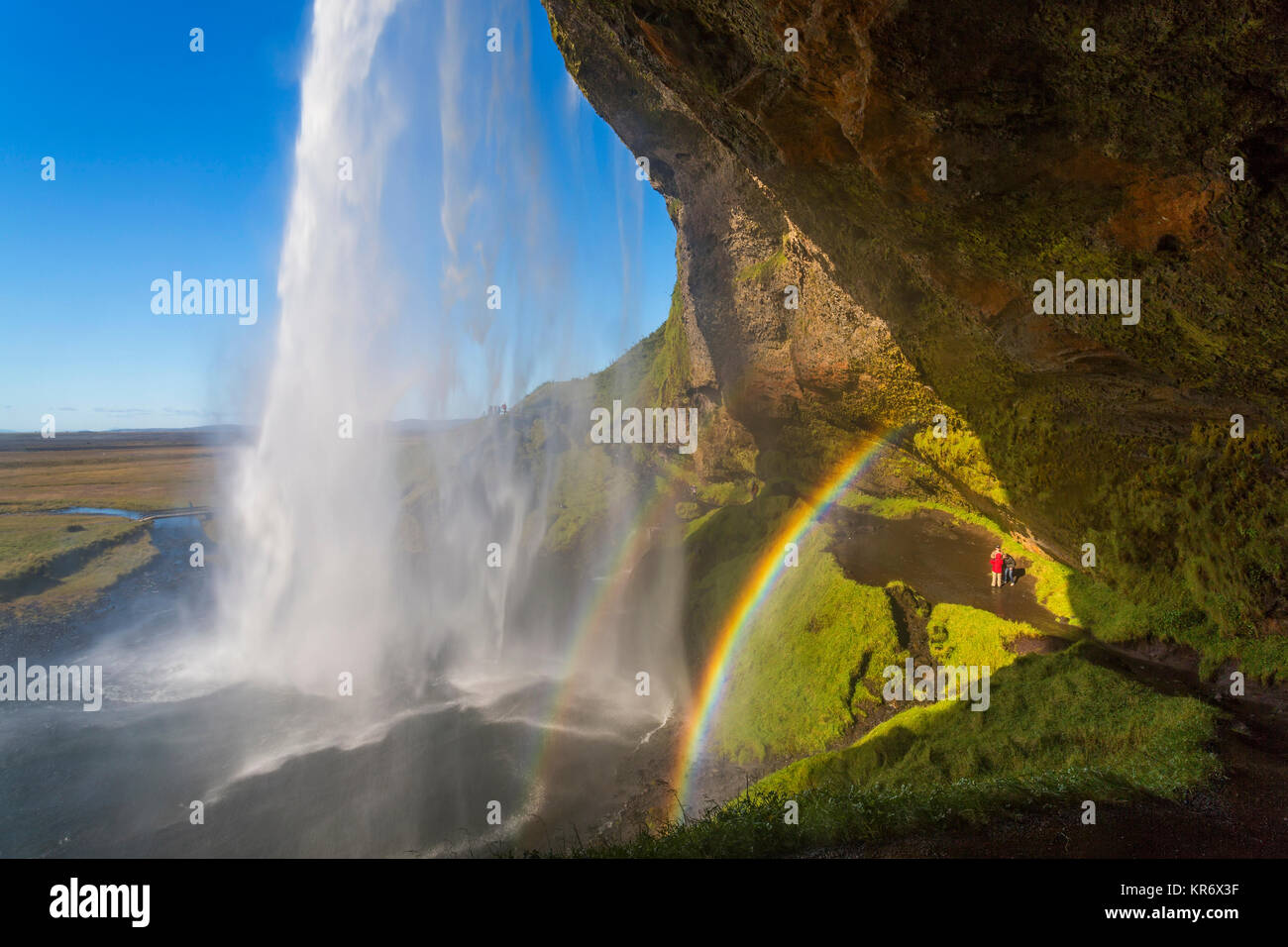 A waterfall cascade over a sheer cliff, a double rainbow in the mist ...