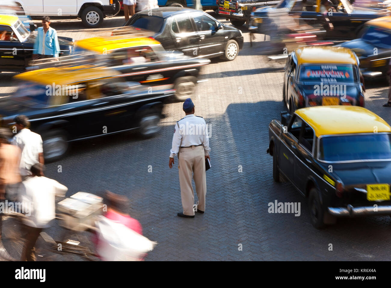 High angle view of man standing in the middle of a busy street ...