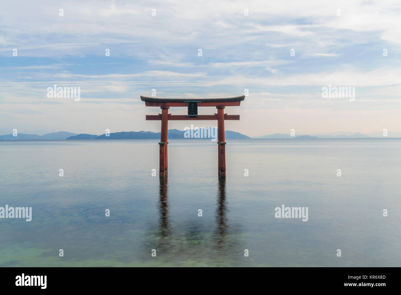 Tall red lacquered Torii gate in the middle of a lake Stock Photo - Alamy